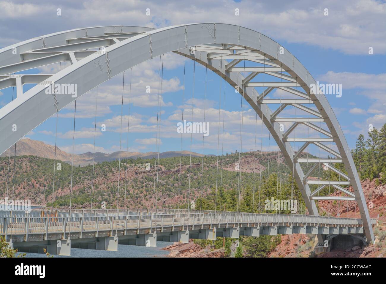 Cart Creek Arch Bridge stretched across a red rock canyon in Flaming ...
