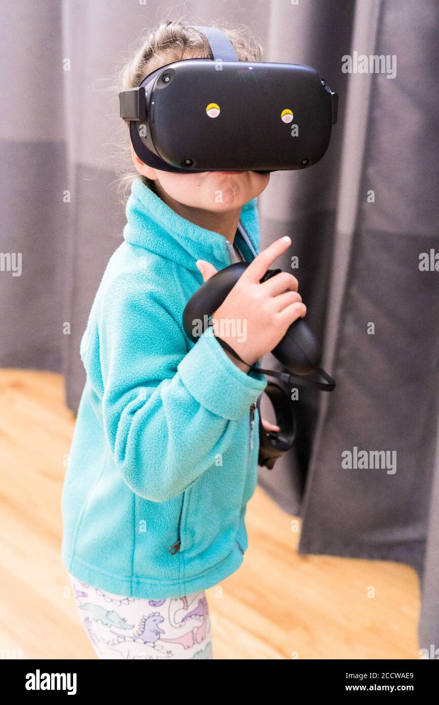 Little girl playing VR kids game in the living room Stock Photo - Alamy