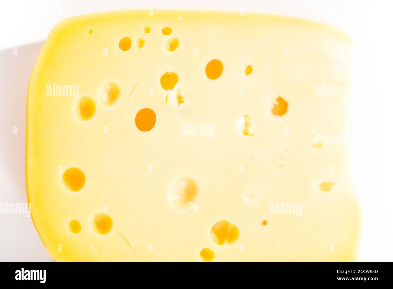 Large slice of semi soft part skim cheese on a white background Stock ...