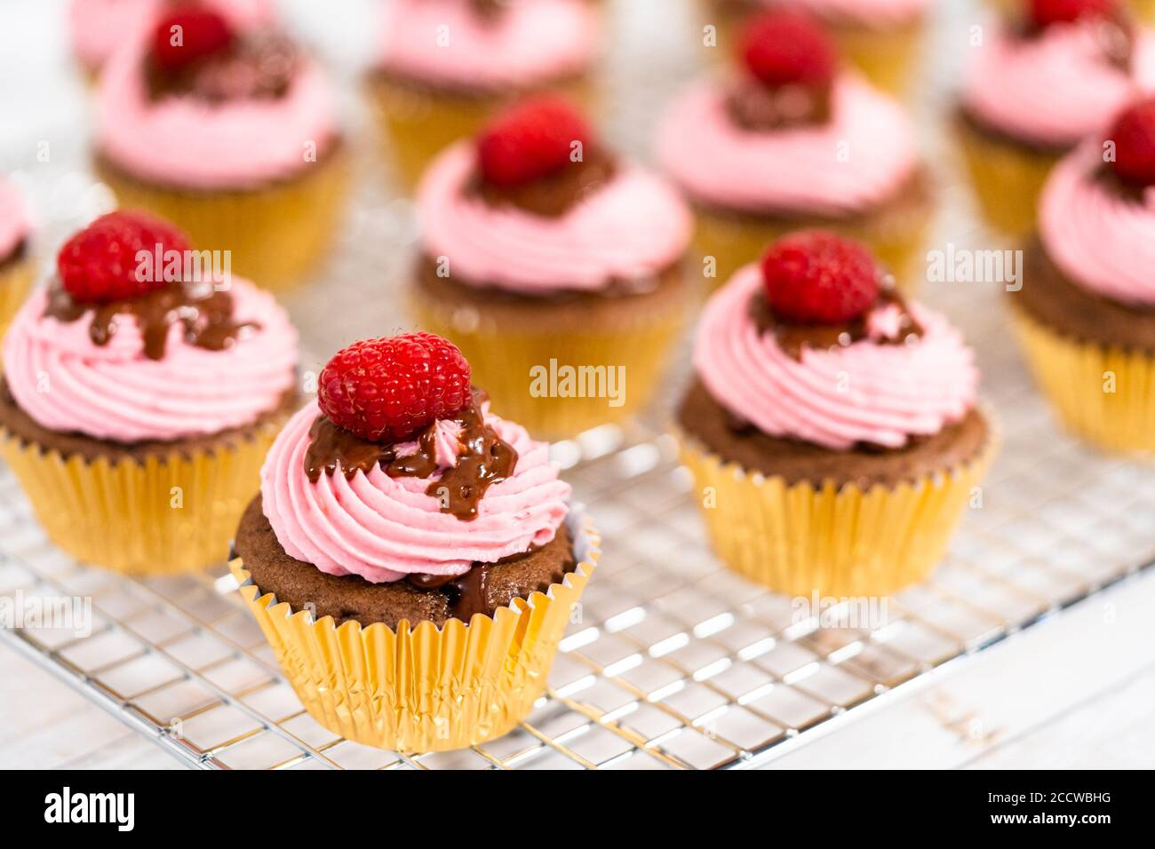 Gourmet chocolate raspberry cupcakes drizzled with chocolate ganache ...