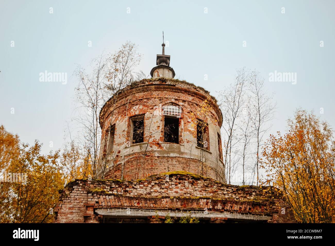 Old abandoned stone house in the autumn forest. The ruins of an ancient ...