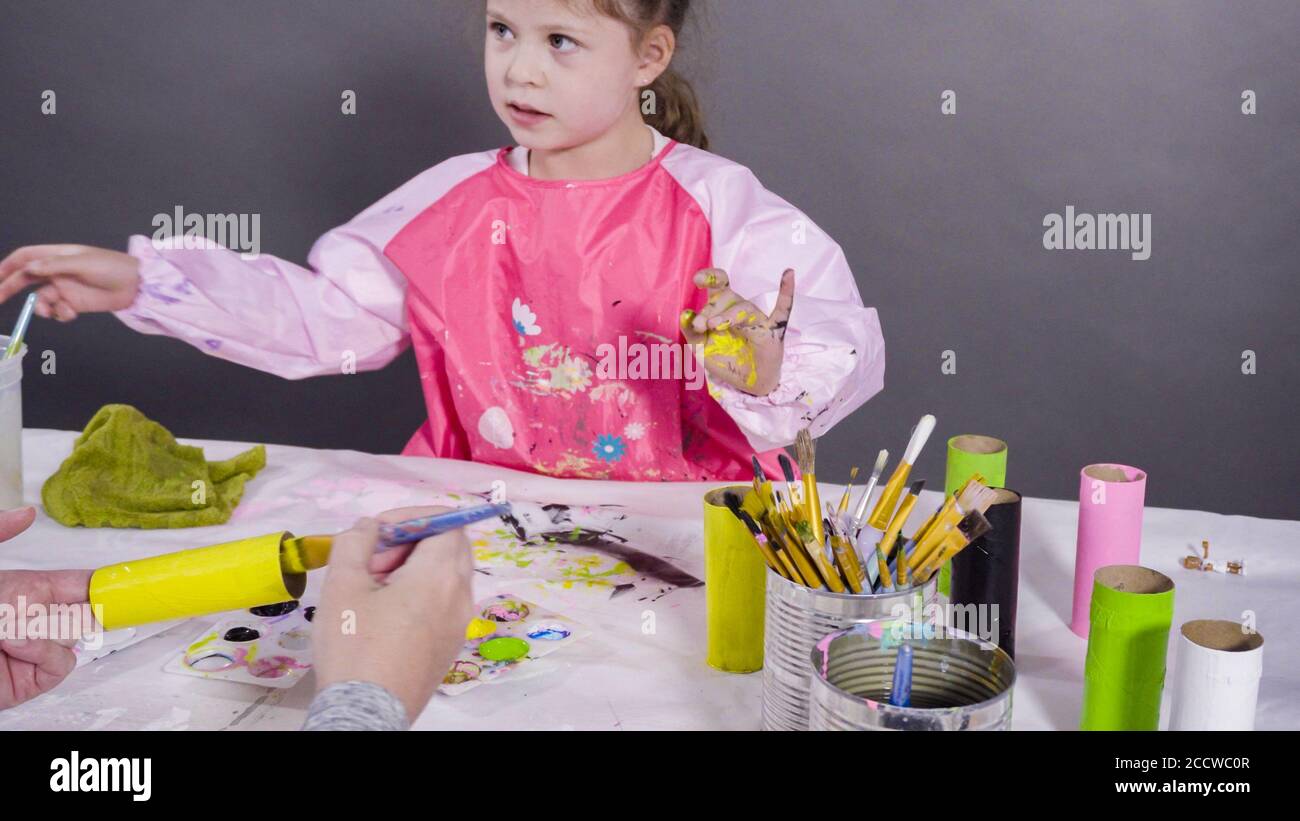 Kids papercraft. Painting empty toilet paper rolls with acrylic paint ...