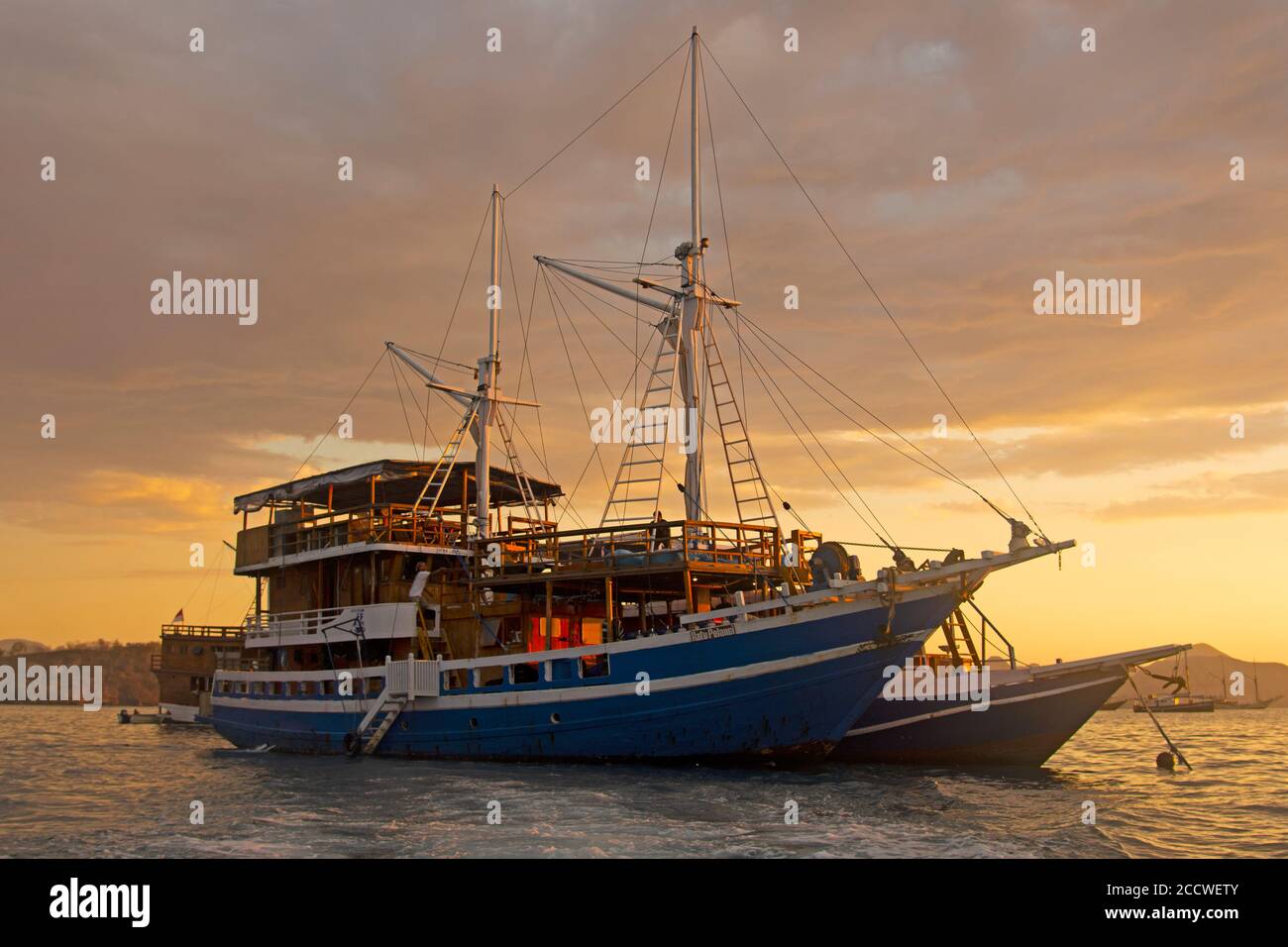 Phinisi, a typical liveaboard dive boat anchored in Labuan Bajo marina ...