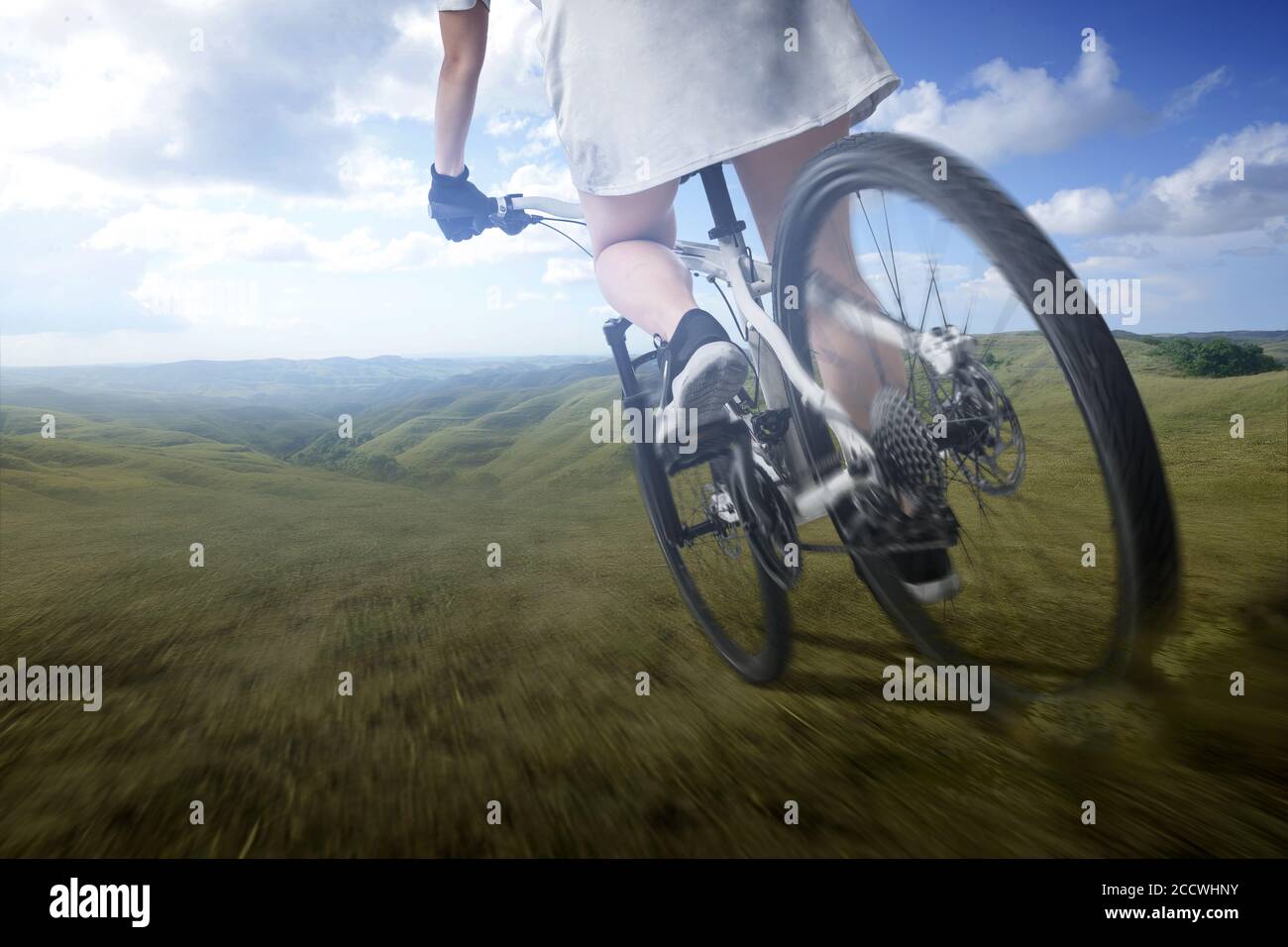 Woman cycling field rear view hi-res stock photography and images - Alamy