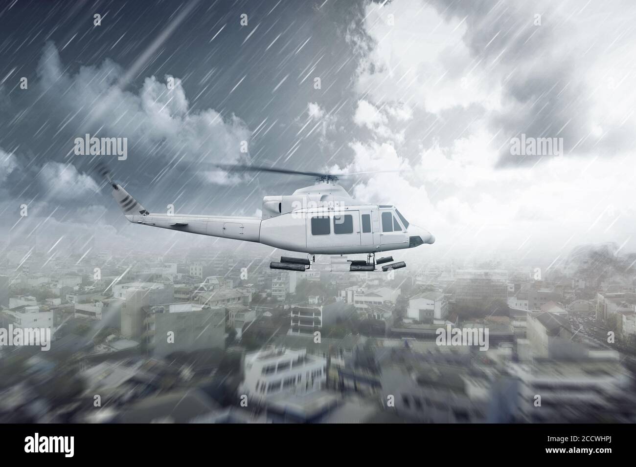 Helicopter flying in the air with rainy weather Stock Photo - Alamy