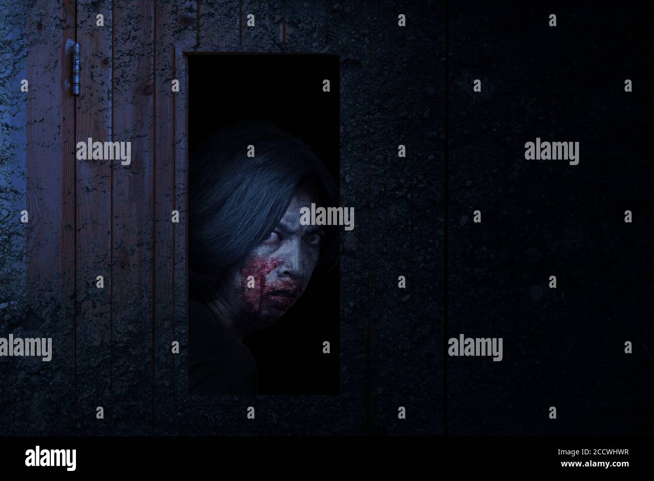 Scary zombie standing behind the door with dark background Stock Photo ...