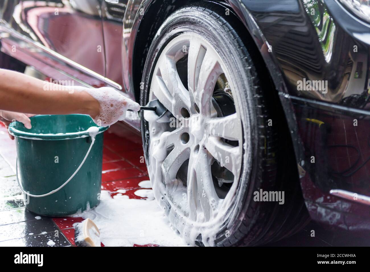 Man washing car wheels hi-res stock photography and images - Alamy
