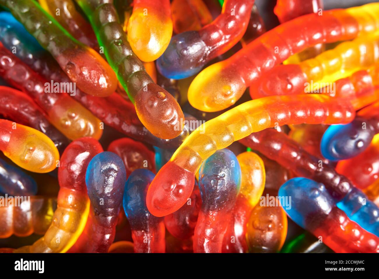 Colorful and bright assorted gummy worms filling the frame, close-up ...