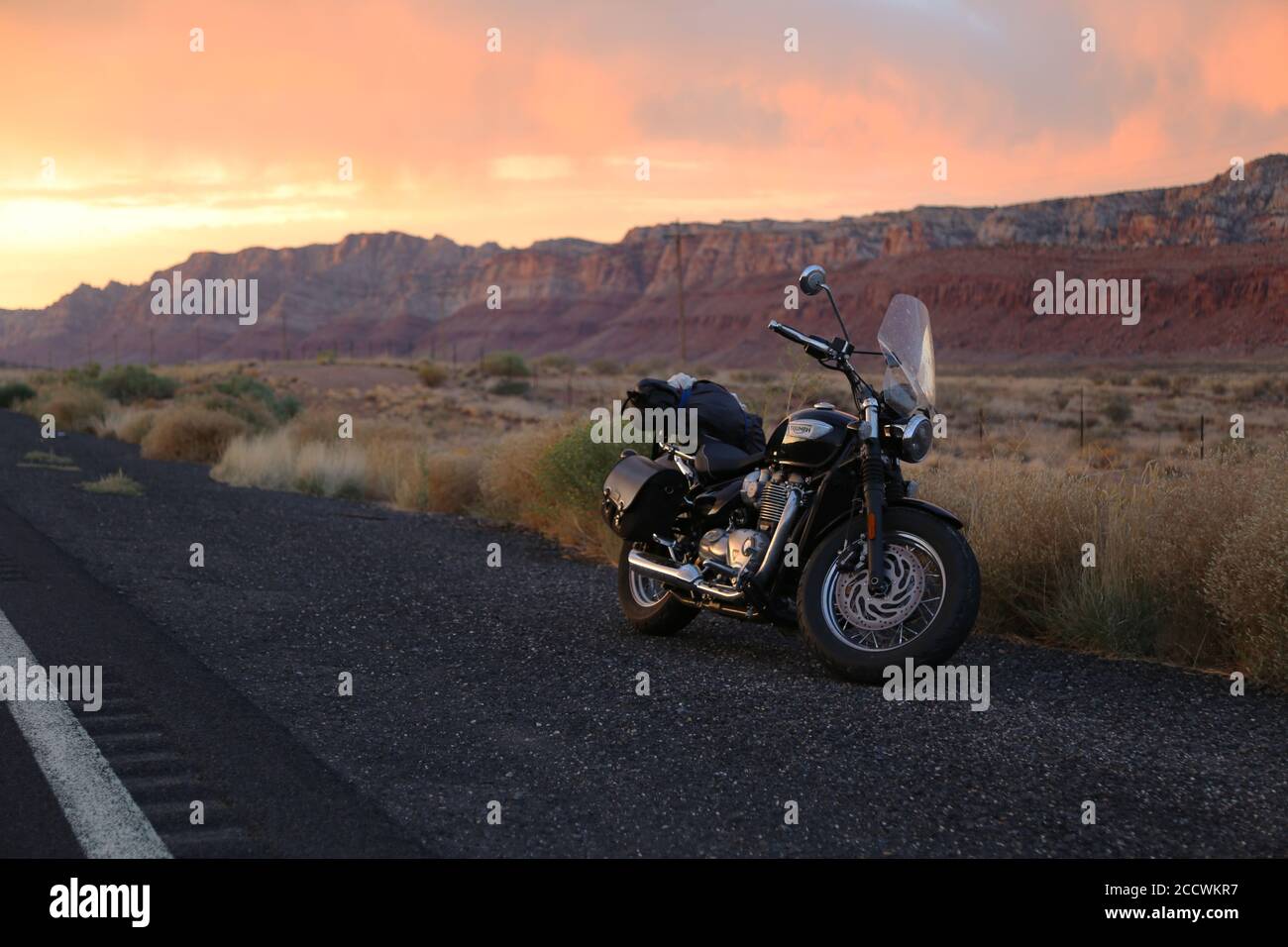 A 2018 Triumph Bonneville Speedmaster on a road trip during a spectacular sunset Stock Photo - Alamy