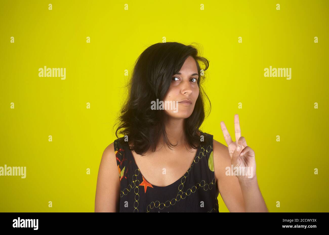 Girl showing two fingers hi-res stock photography and images - Alamy