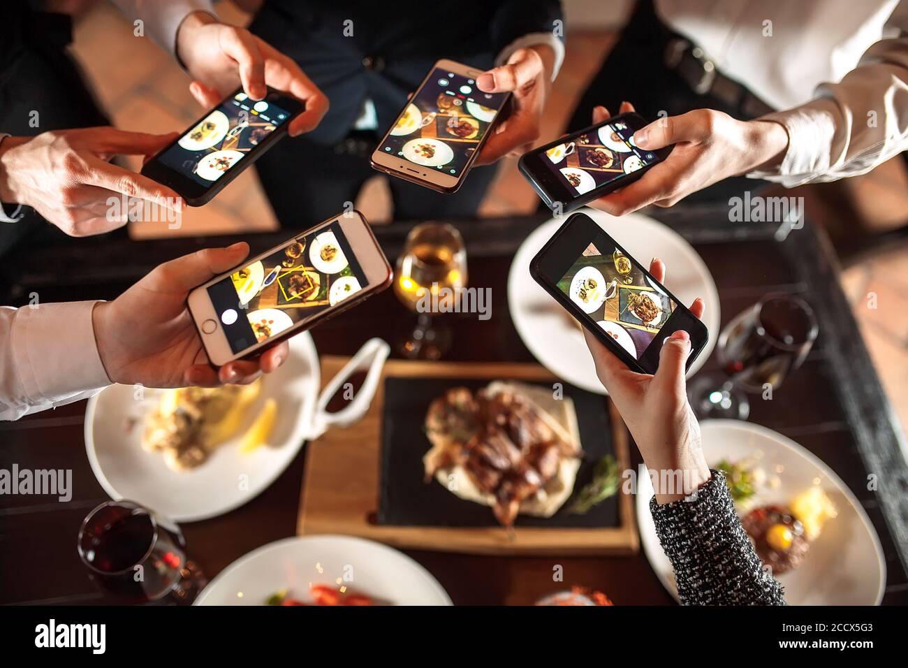 Group of friends going out and taking a photo of food together with ...
