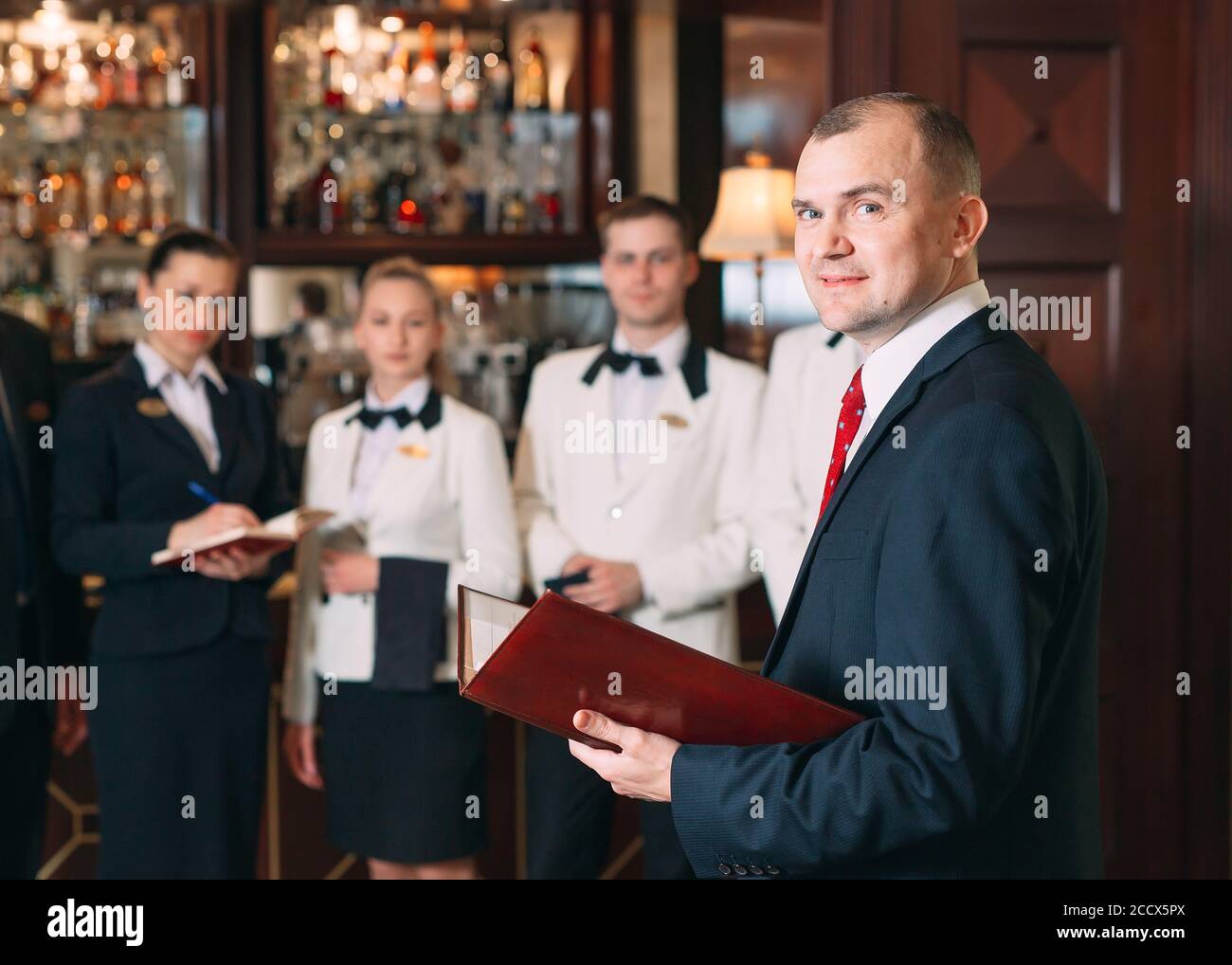 The interaction of the staff. Hotel or restaurant manager and his staff ...