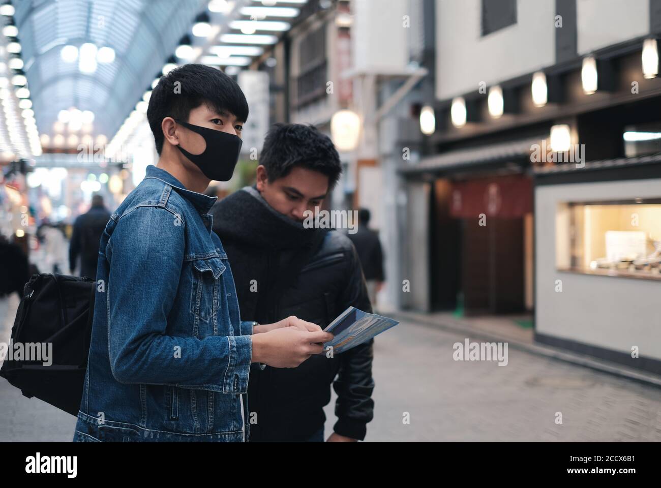 Two young asian men searching the famous place, restaurant and cafe ...