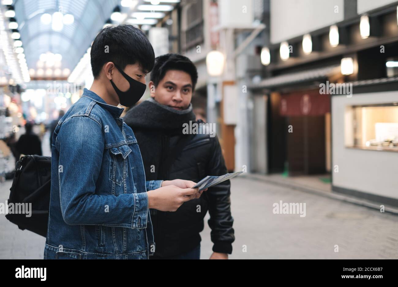 Two young asian men searching the famous place, restaurant and cafe ...