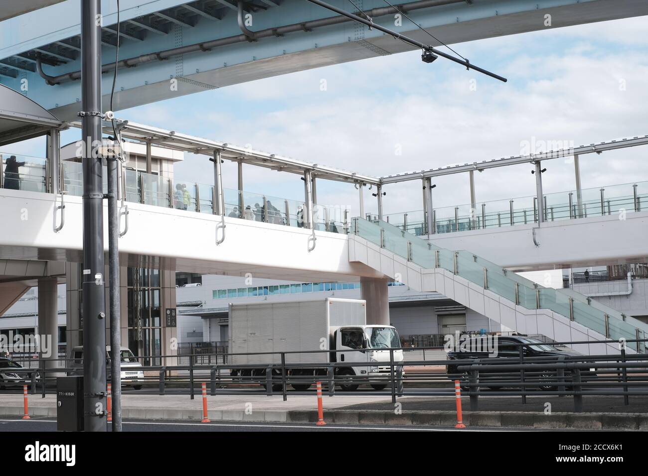 Traffic of people on footbridge and cars driving on the road. City life ...