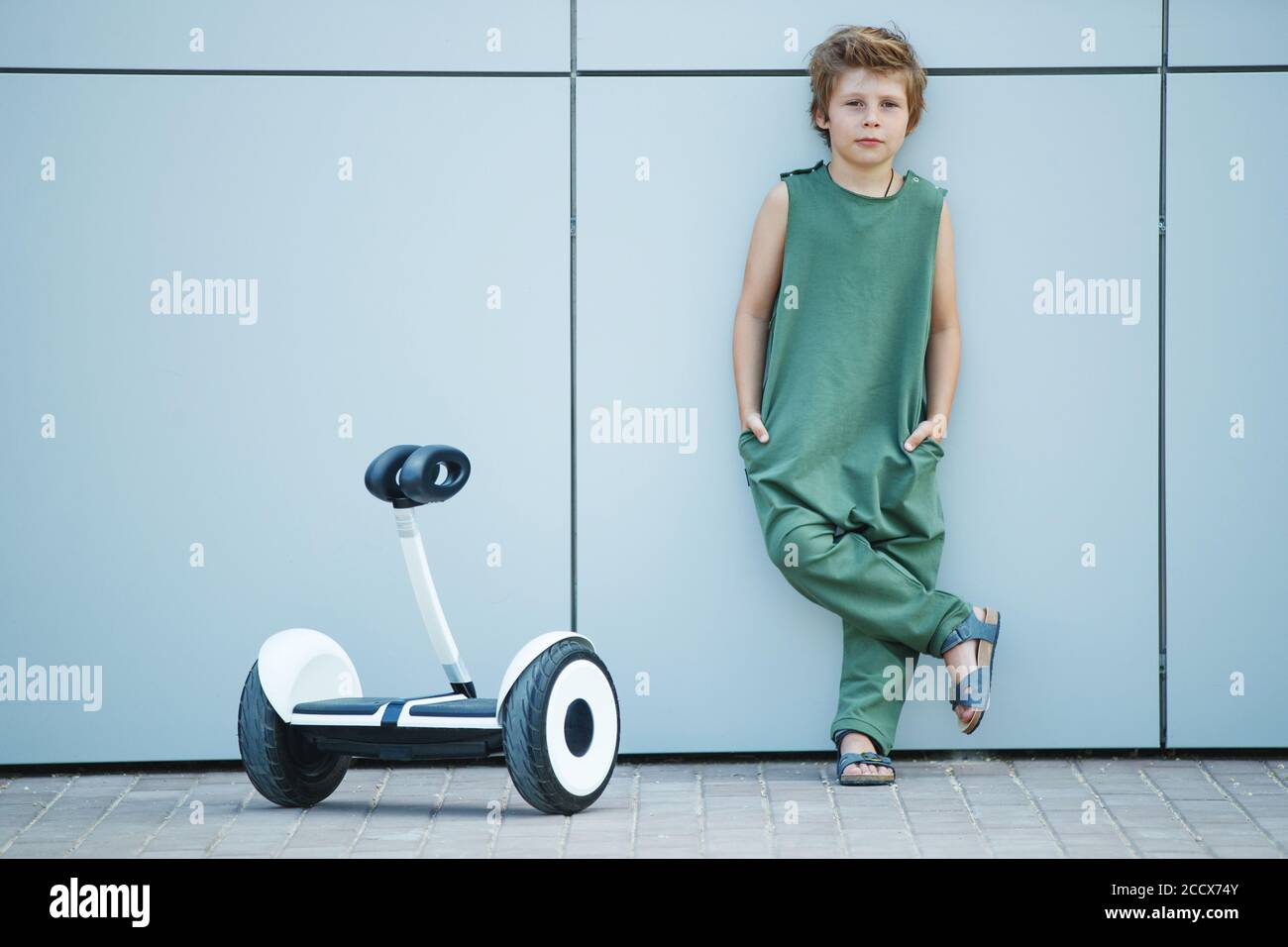 The child goes in for sports. A little boy is riding a hoverboard Stock ...