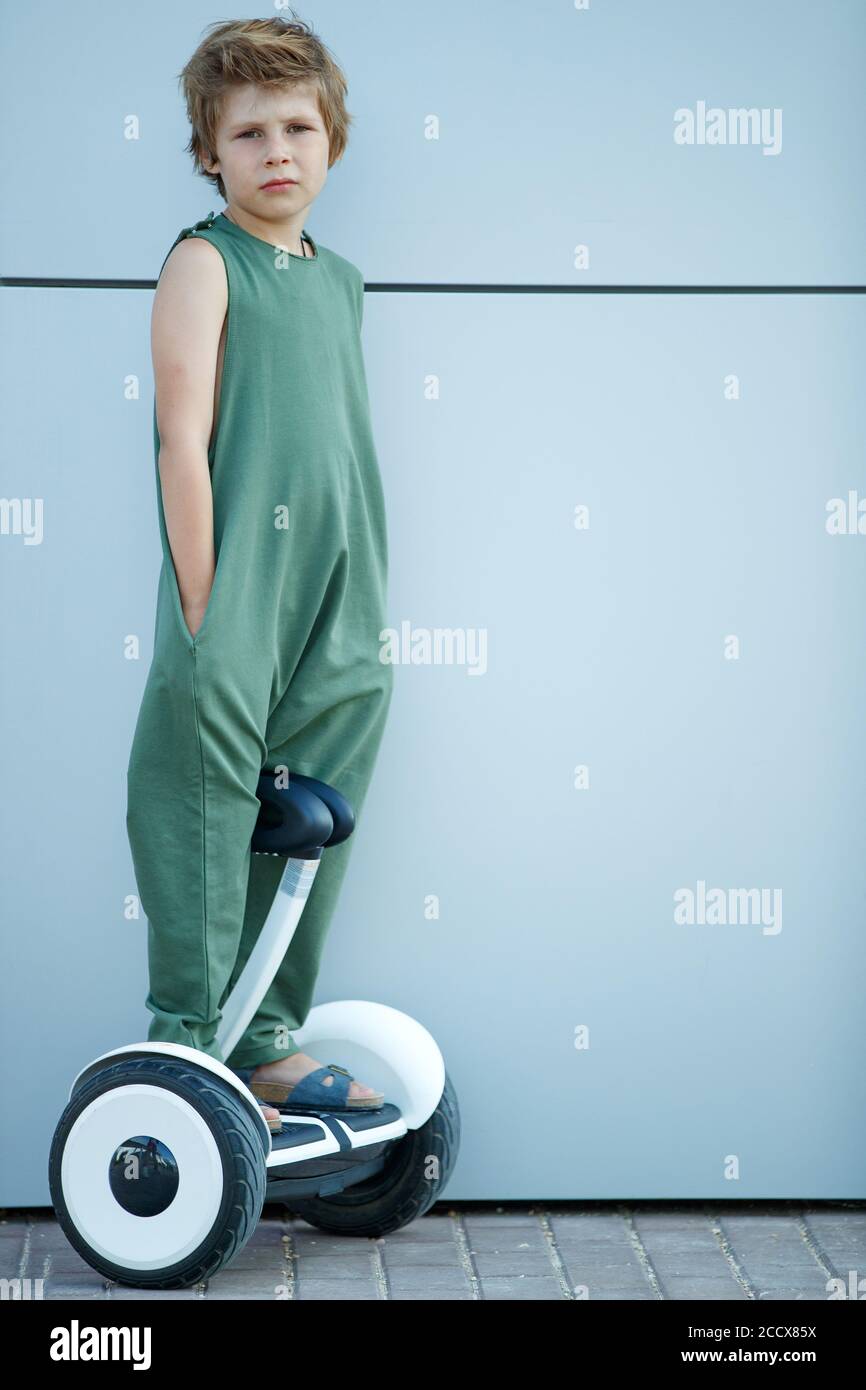 The child goes in for sports. A little boy is riding a hoverboard Stock ...