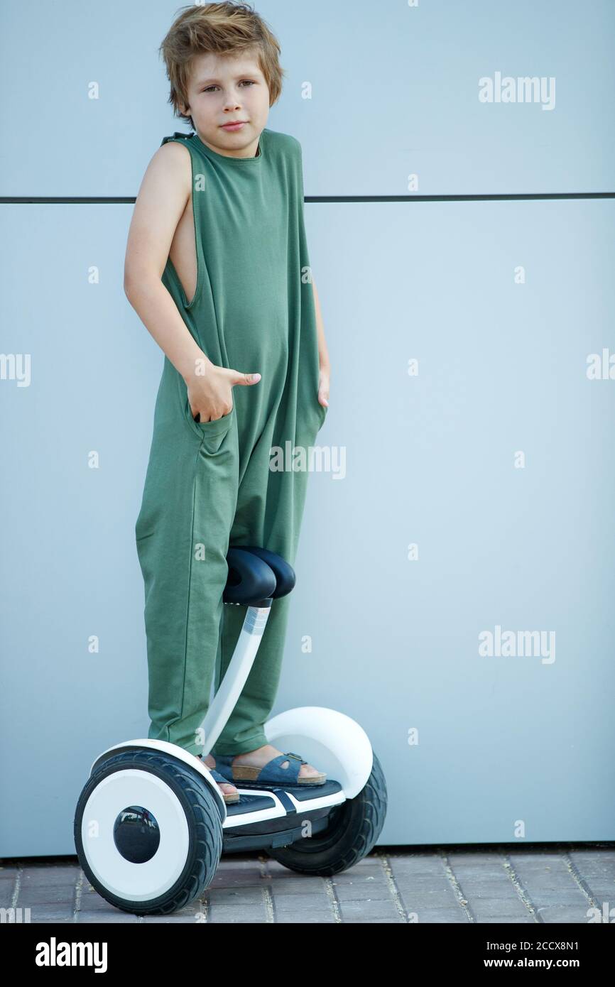 The child goes in for sports. A little boy is riding a hoverboard Stock ...