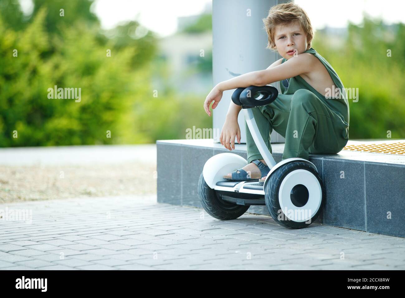 The child goes in for sports. A little boy is riding a hoverboard Stock ...
