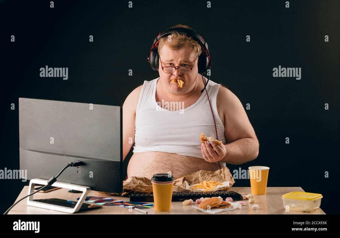unhappy man with potatoes in his mouth posing to the camera. close up ...