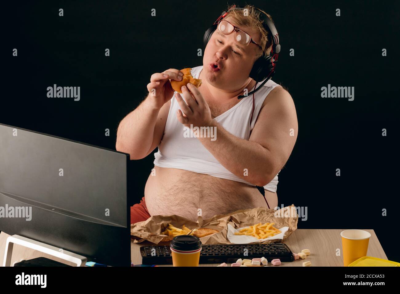 lazy guy eating a burger at night. close up photo. isolated black ...