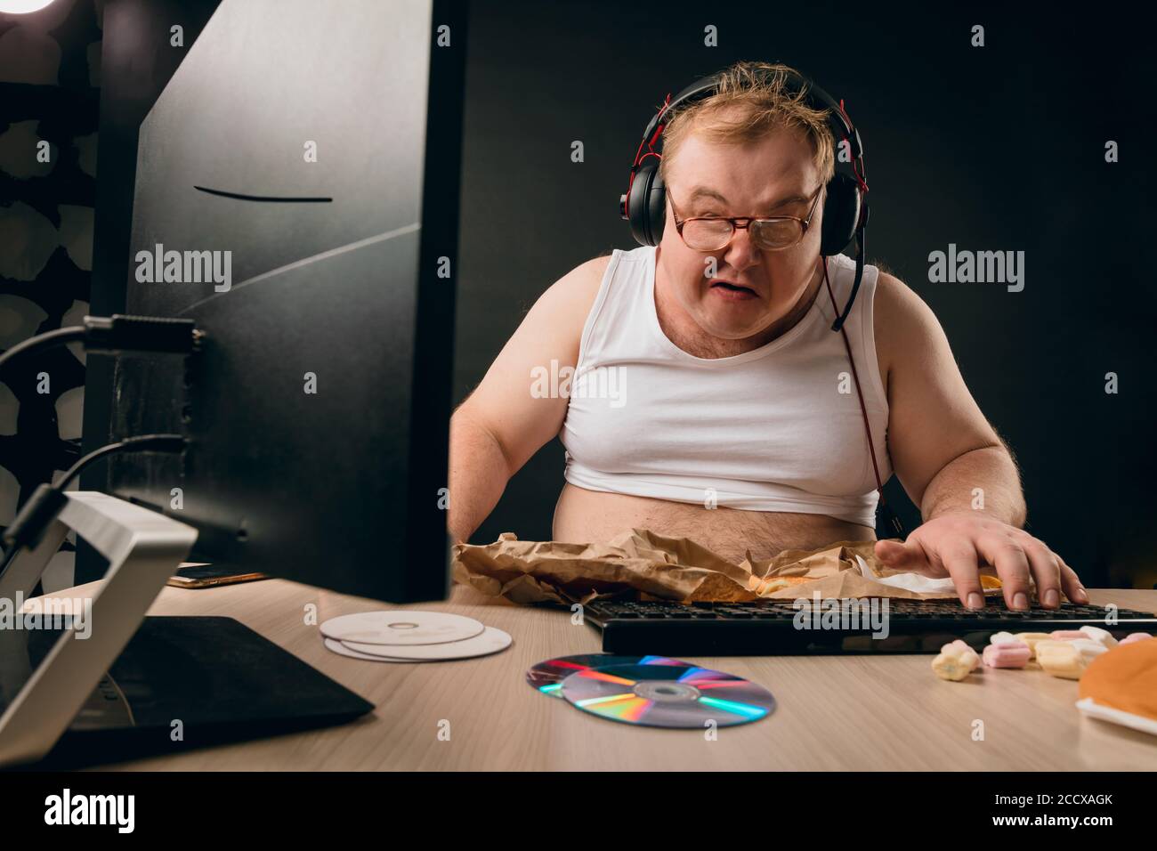 Drunk man sitting at home with computer looking depressed. alcohol ...