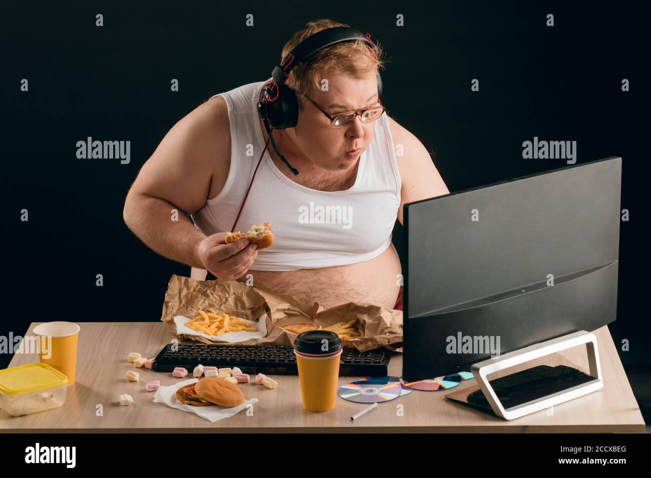 obese guy chatting online with friends isolated over black background ...
