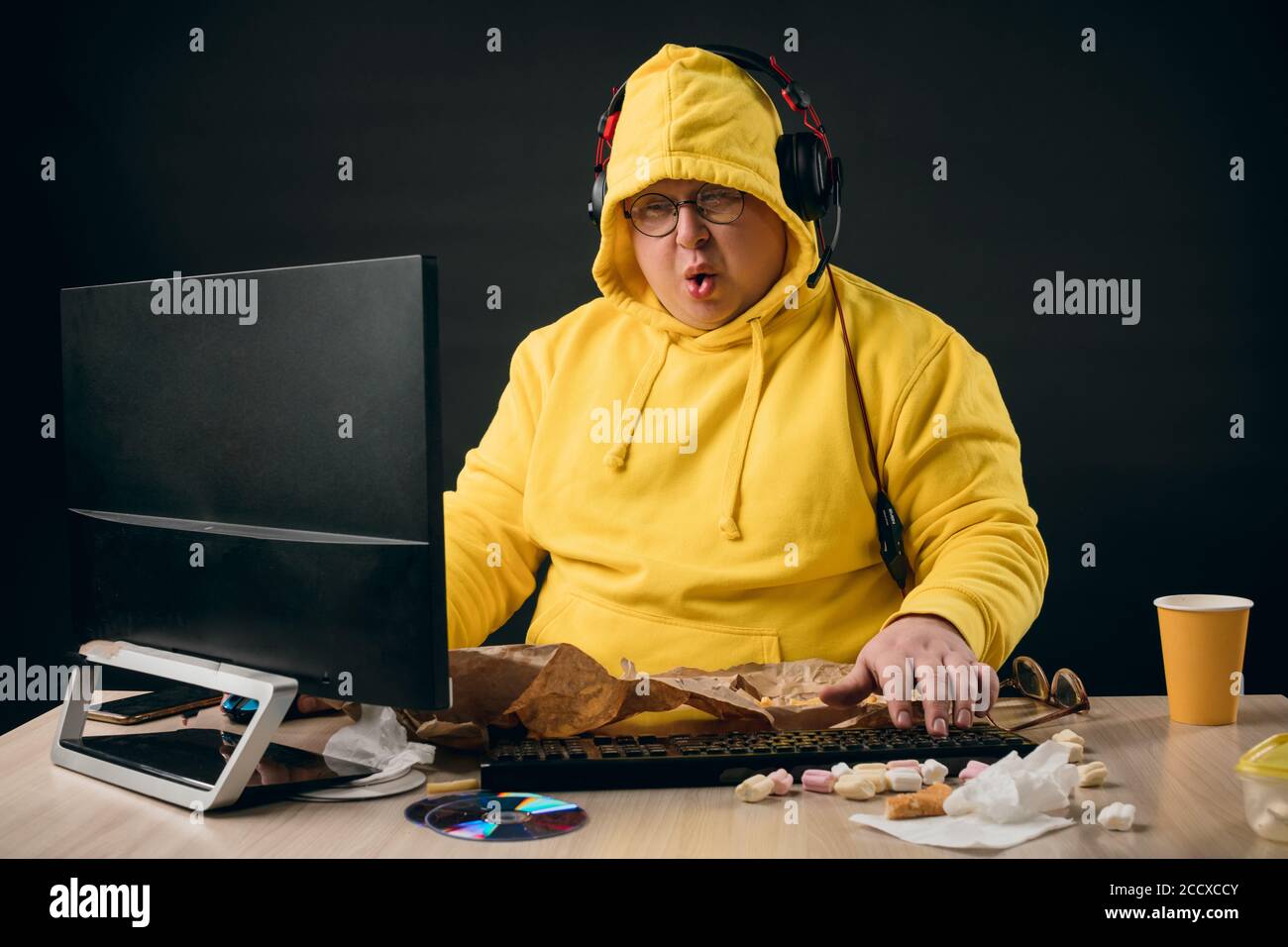 fat man wasting his time while sitting in front of computer. close up ...
