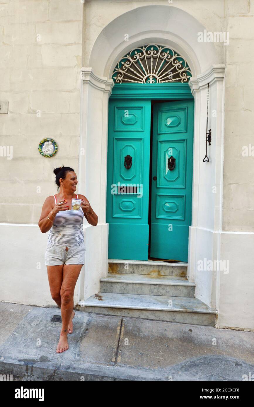 Beautiful woman walking maltese hi-res stock photography and images - Alamy