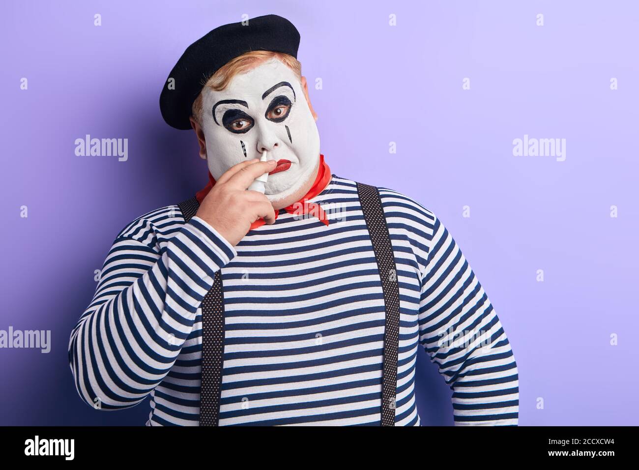 sick poor man treating his nose, isolated blue background. copy space ...