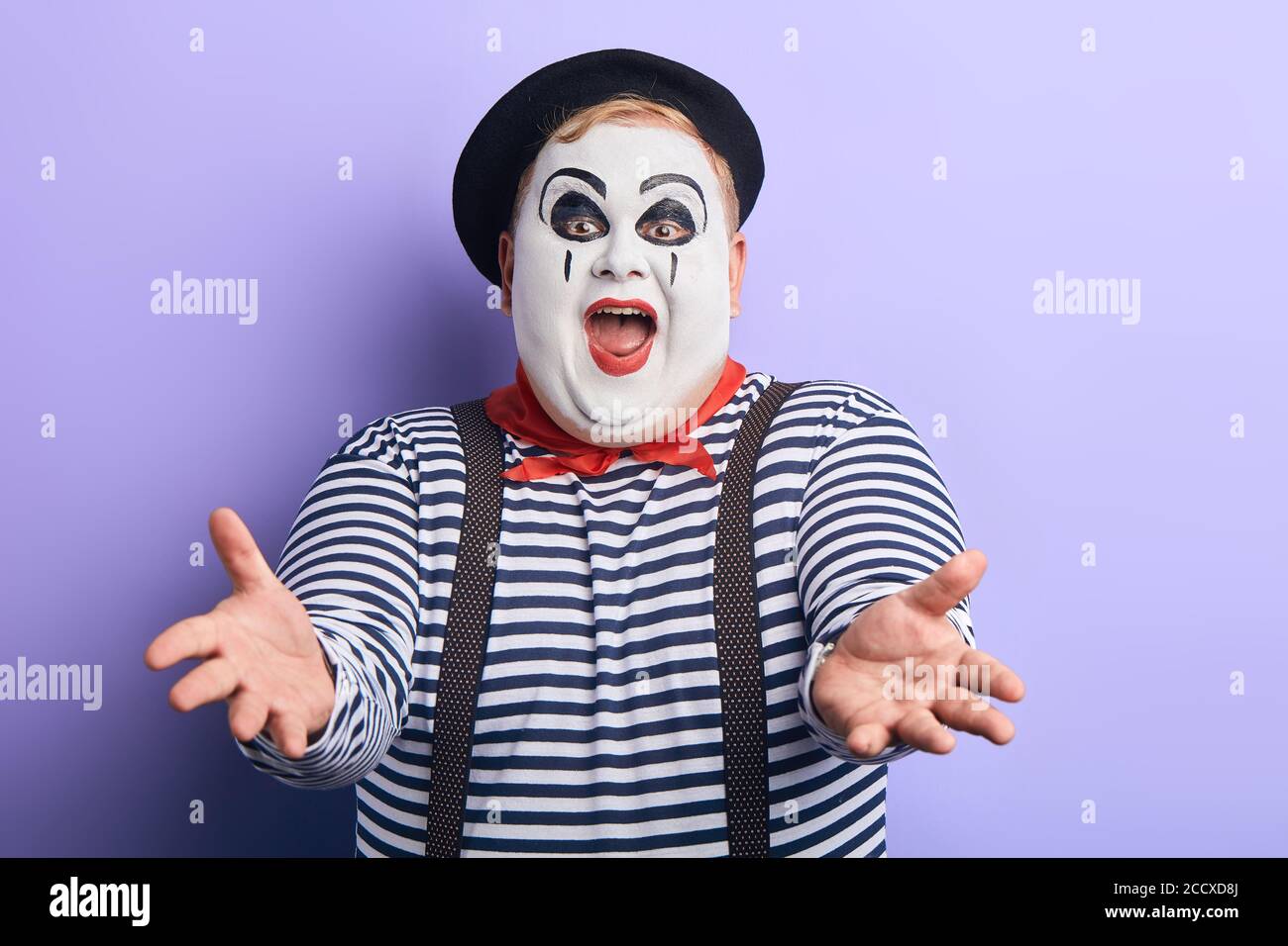 positive mime entertaining kids during the party.close up portrait ...