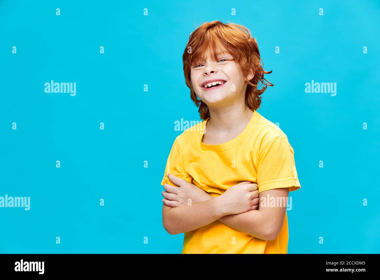 Happy red-haired boy laughs and crossed his arms over his chest Stock ...