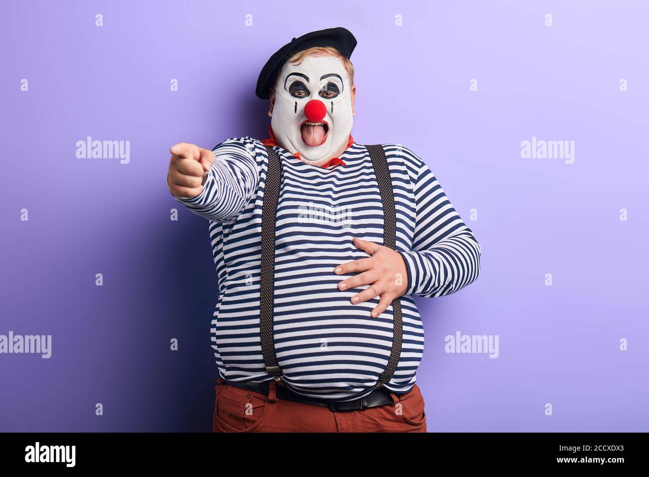funny crazy fat artist touching his stomach, laughing, isolated blue ...