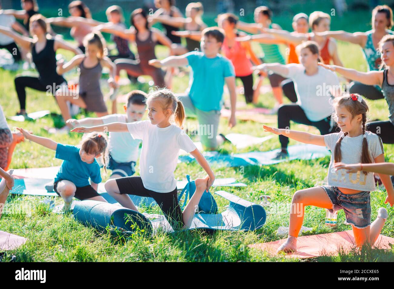 Yoga classes outside on the open air. Kids Yoga Stock Photo - Alamy