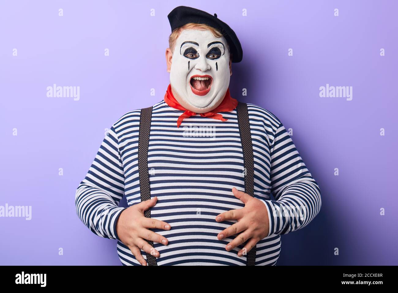 fat positive mime artists touching his stomach and laughing at the ...
