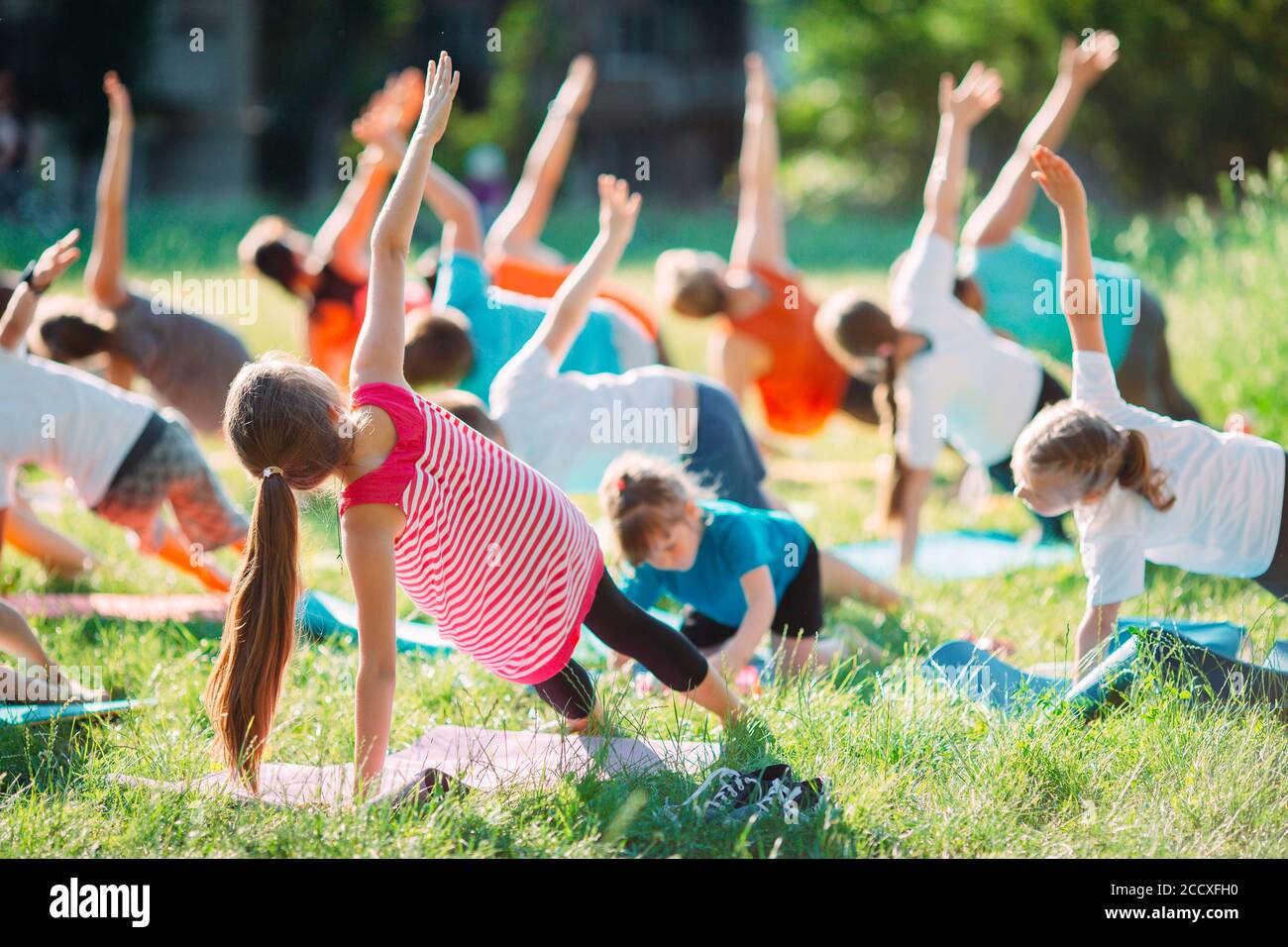 Yoga classes outside on the open air. Kids Yoga Stock Photo - Alamy