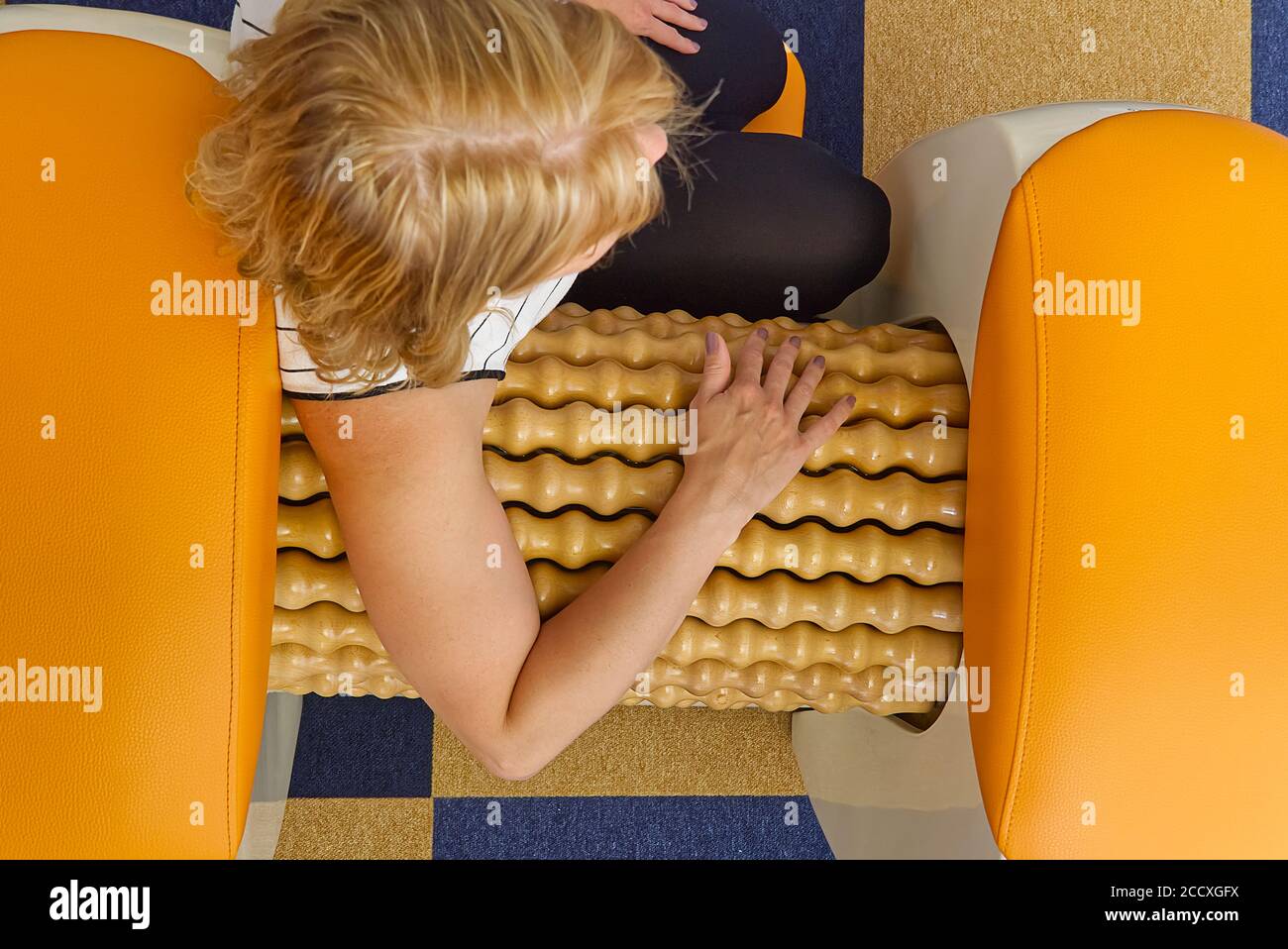 woman making massage for hand. Roll Massage machine is a way to shape ...