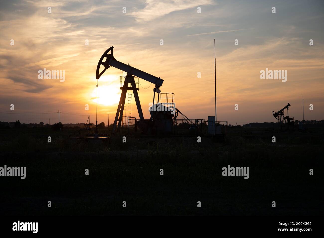 Oil Pump on orange sunset Stock Photo - Alamy