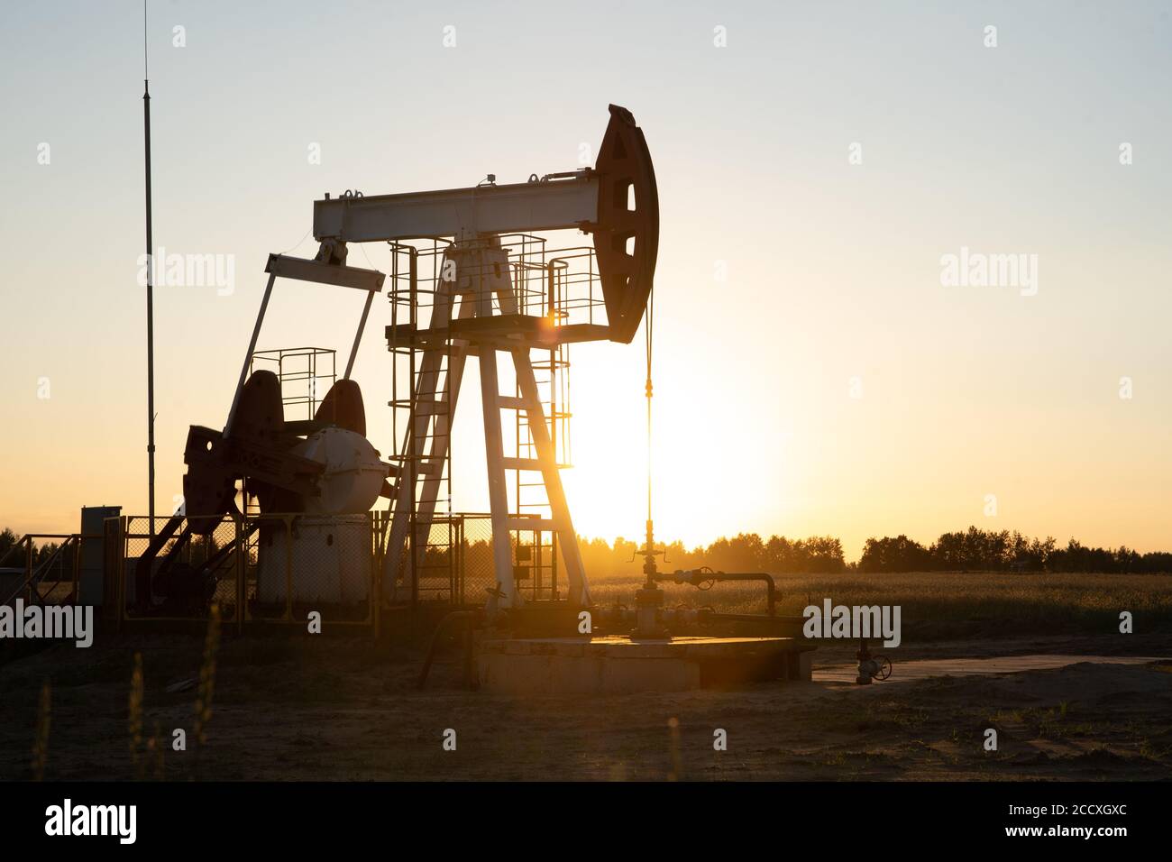 Oil Pump on orange sunset Stock Photo - Alamy