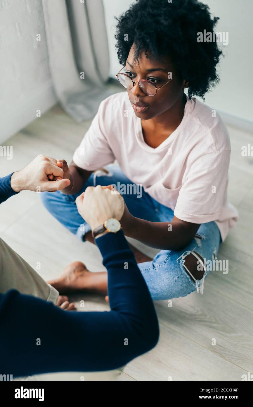 African woman sitting hands on legs hi-res stock photography and images ...