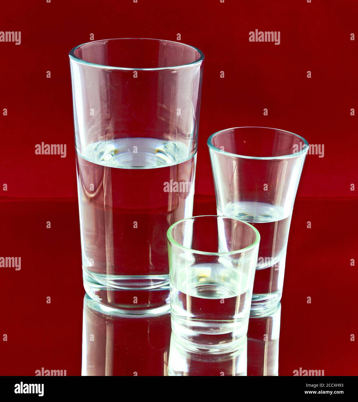 Water in Glass's on a Red Background Stock Photo - Alamy
