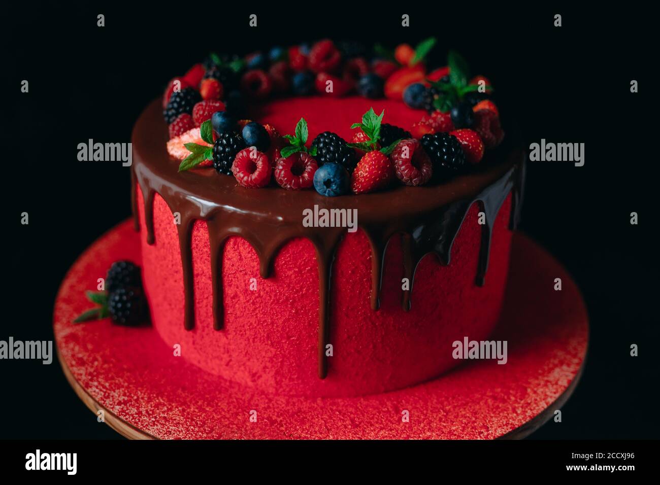 Red velvet summer fruit cake on the black background Stock Photo - Alamy