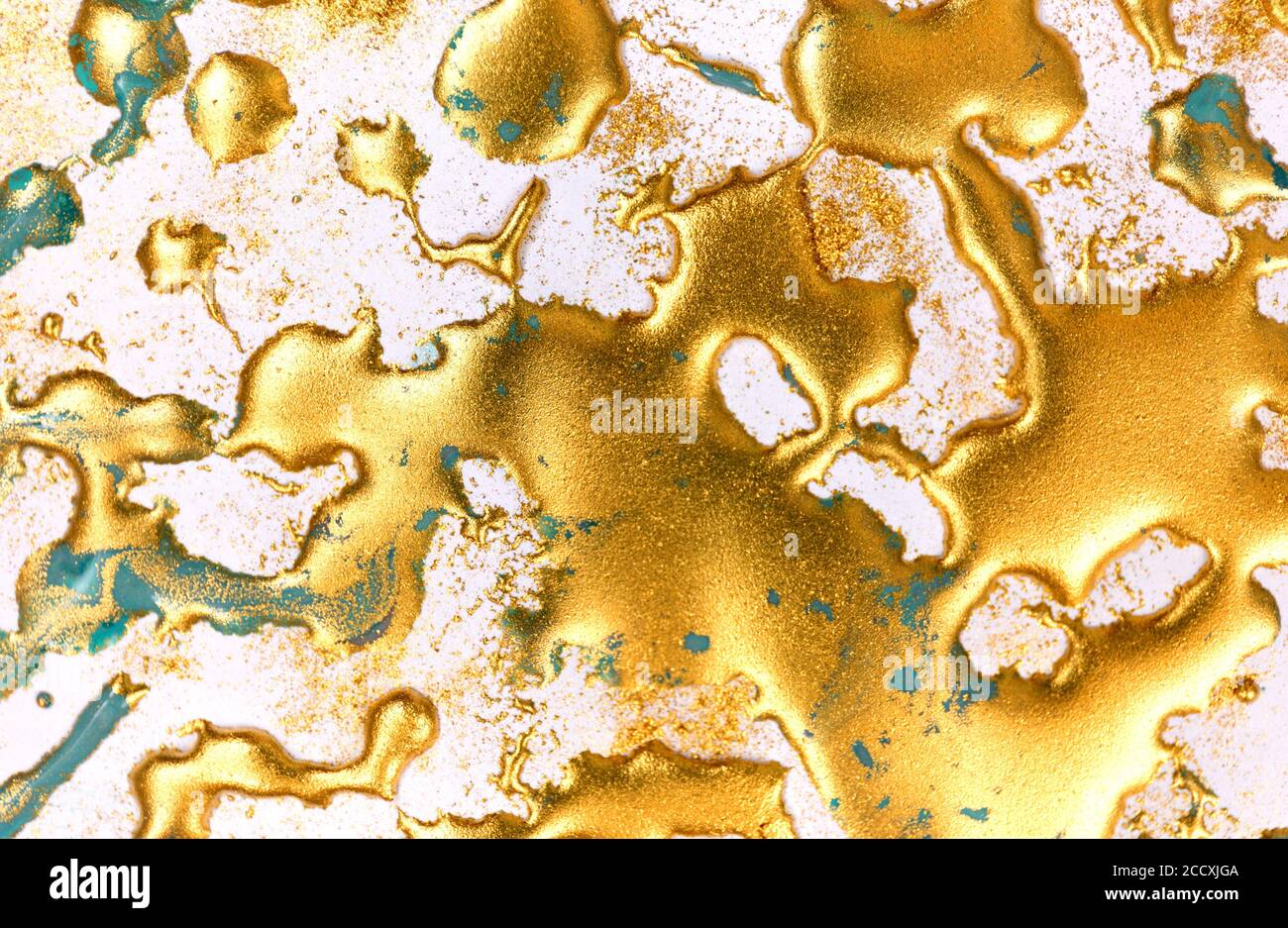 Golden ink drops on white paper background Stock Photo - Alamy