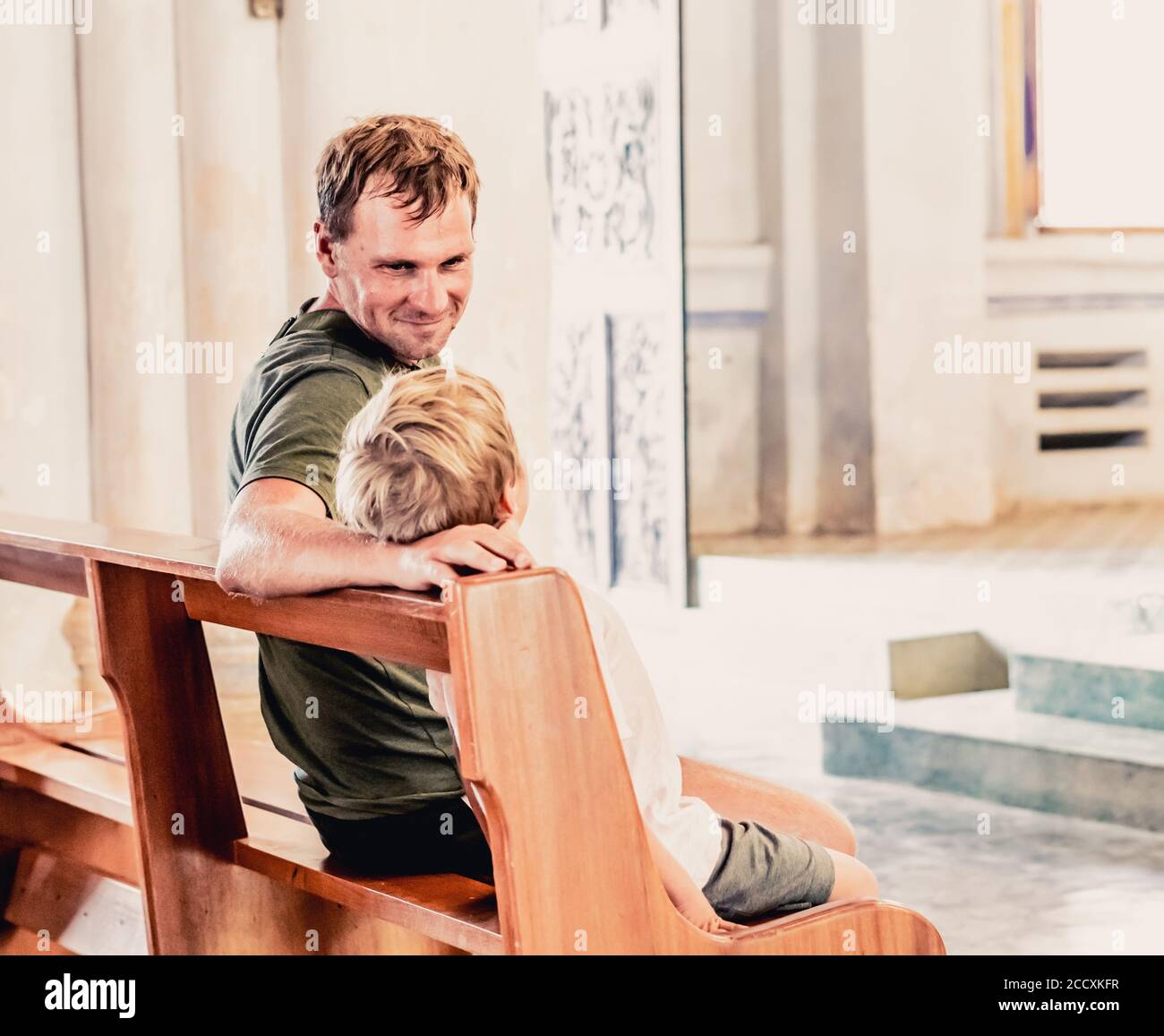 Christian dad tells his son Bible stories about Jesus sitting in kirk ...