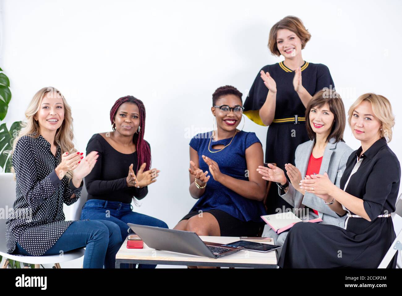 business team of caucasian female business partners and african female ...