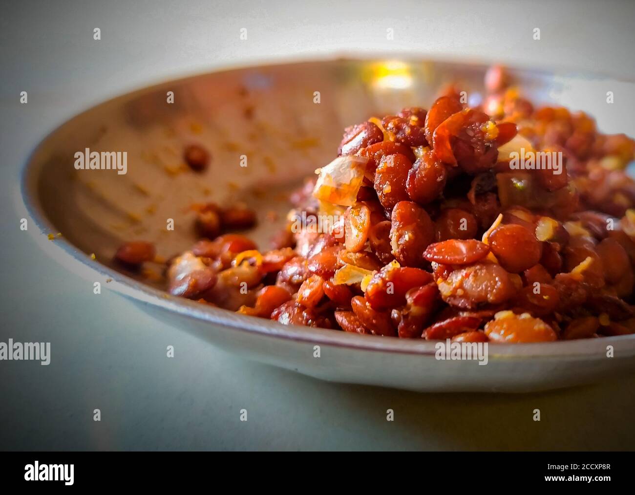 Spicy fried lentil grains in steel plate Stock Photo - Alamy