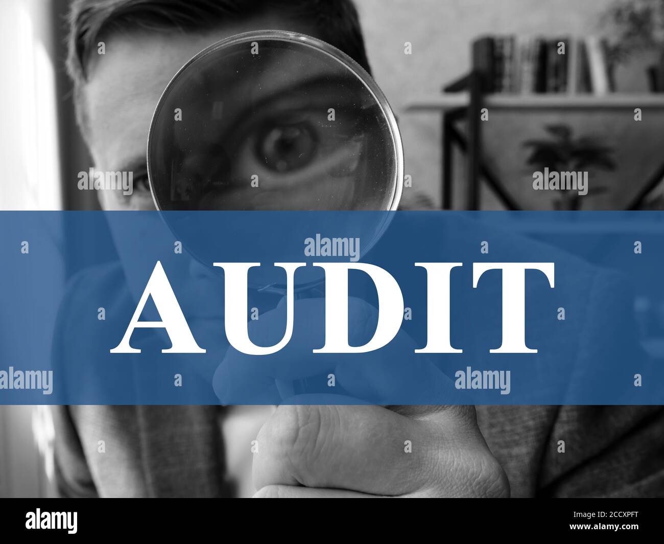 Audit concept. Auditor with a magnifying glass in office Stock Photo ...