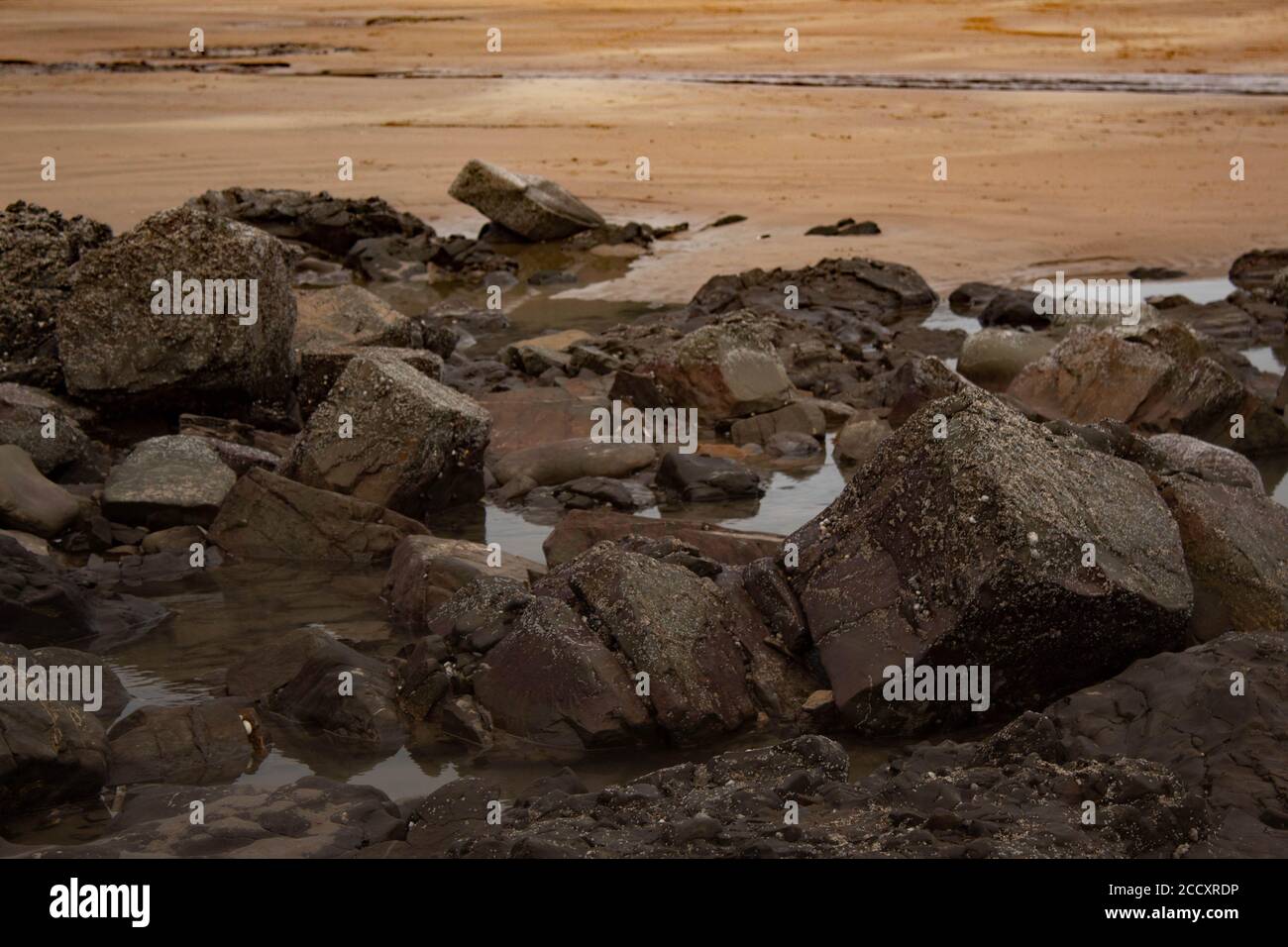 Volcanic rocks on a beach after cliff collapse Stock Photo - Alamy