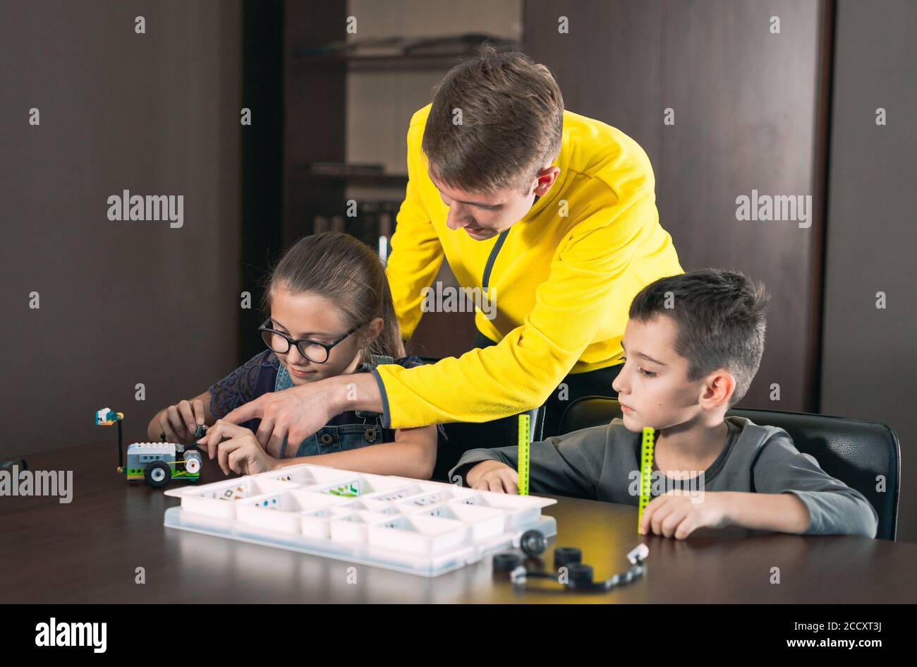 Kids creating robots with teacher. Early development, diy, innovation ...