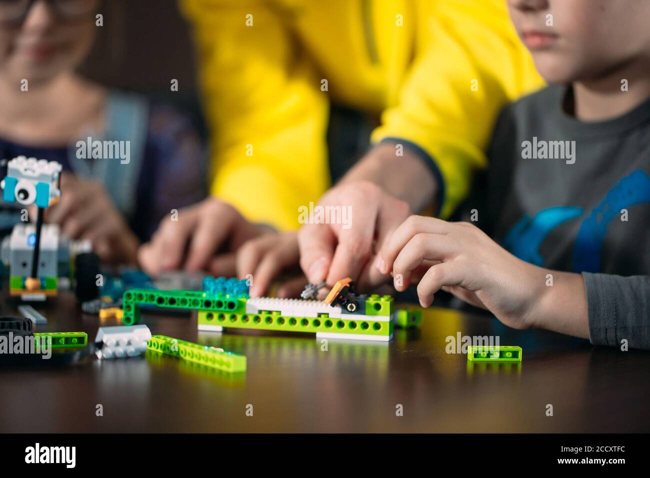 Kids creating robots with teacher. Early development, diy, innovation ...